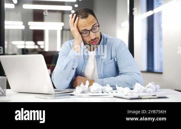 Overworked african american businessman is bored sitting at workplace ...