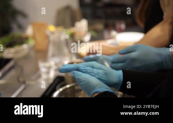 Blue gloves, gloved hands, food safety. Close-up hands wearing blue ...