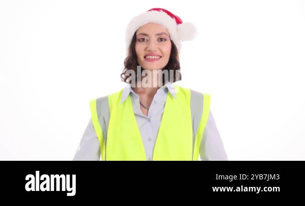 Woman builder wearing Santa hat holds 2025 year digits on white ...