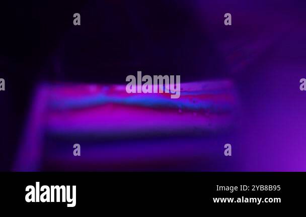 Red Purple multi-colored liquid in macro, color change and reflection ...