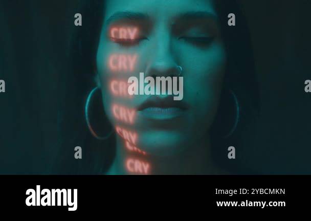 A reflective woman has the word CRY prominently projected on her face ...