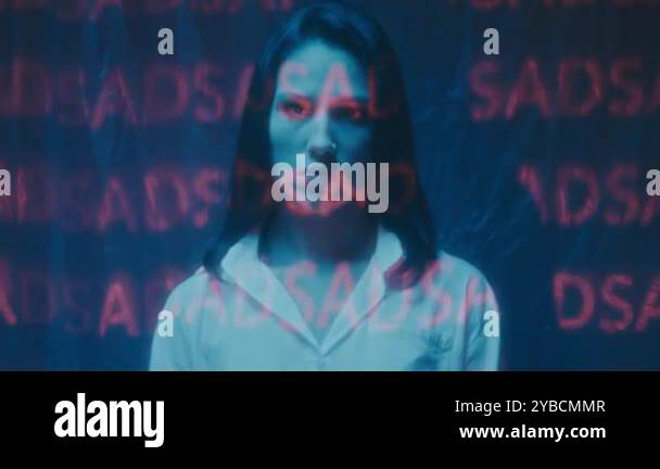 A reflective woman has the letters and digital patterns prominently ...