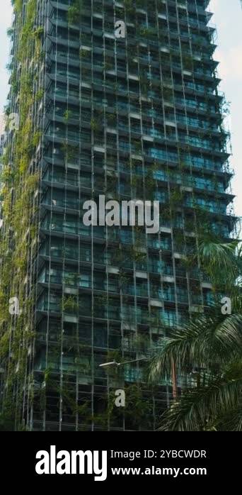Modern high-rise building with vertical gardens integrated into its ...