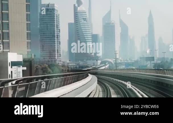Dubai, UAE - May 5, 2024: Dubai metro train passing through modern ...