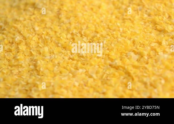 Corn porridge rotates, side view. Slow rotation. Flakes of instant corn ...