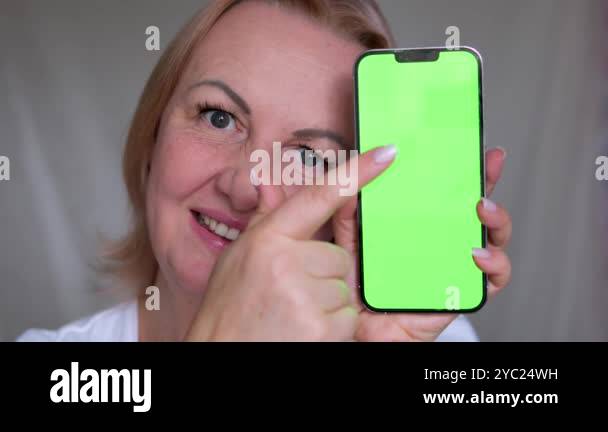 Green screen mobile phone mockup key in business woman hands searching ...