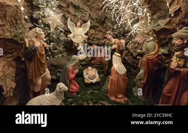 Jesus Christ Nativity scene in atmospheric lights near Christmas tree ...