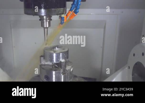 The pan scene the CNC milling machine cutting the mold parts with oil ...