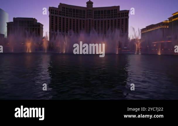 Evening view of Bellagio Fountains in Las Vegas with illuminated water jets performing ...