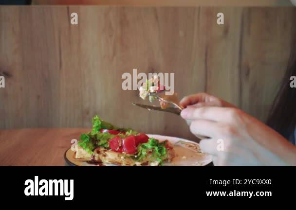 A peaceful indoor dining scene, featuring a woman enjoying a light meal ...