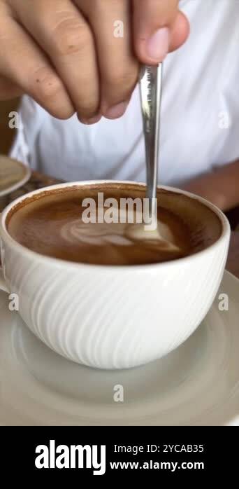 Gentle swirling of coffee with rich foam, emphasizing its delightful ...