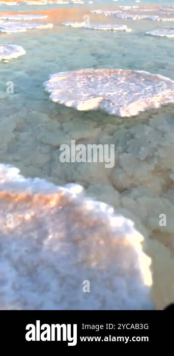 Rough salt crust blends into turquoise water, sunlight enhancing ...