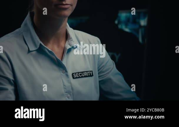 Medium midsection shot of anonymous female security guard in uniform shirt, with badge answering ...