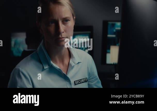 Medium closeup slowmo of face of young Caucasian female security guard ...