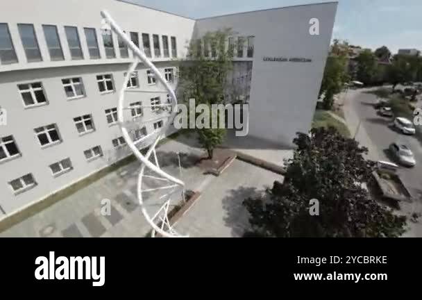 The video shows a white, double-stranded DNA helix sculpture on a ...