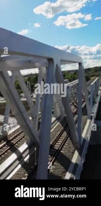 The video starts with a view of a bridge from above. The bridge is a ...