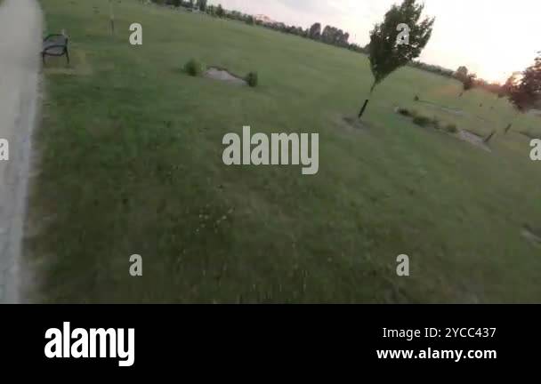The video starts with a first-person view FPV drone shot of a park. The ...