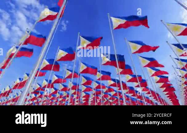 Philippine national flags waving in the wind against a blue sky ...