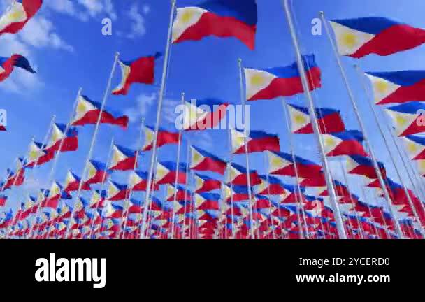 Philippine national flags waving in the wind against a blue sky ...