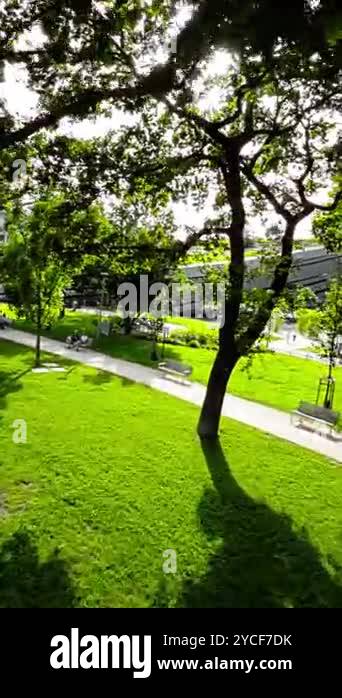 This video takes you on a walk through a modern city park. The park is ...