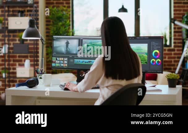 Asian woman uses advanced editing software in a modern office. Working ...