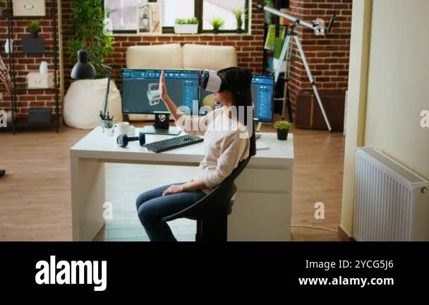 Asian woman engineer creating prototypes with vr glasses and 3D modeling software, working from ...