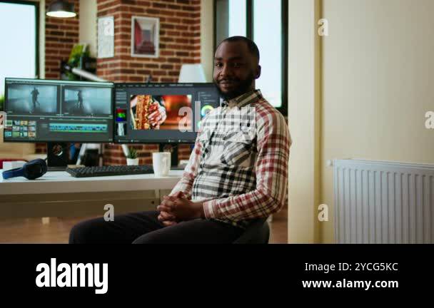 African american male filmmaker works with creative editing software ...
