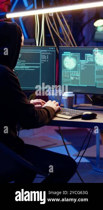 Vertical video Jolly hacker in graffiti painted hideout excited after ...