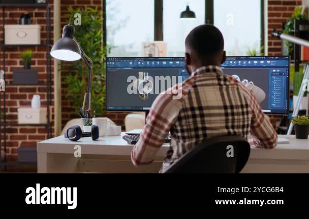 Engineer designs a turbine in an industrial office using CAD software ...