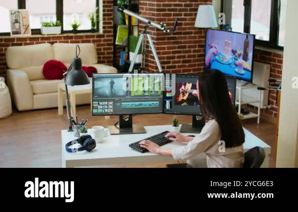 Asian woman editing a music video in her living room studio, multitasking between timeline ...
