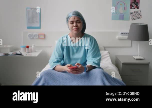 Zoom out portrait shot of gen Z female patient in medial cap and gown with pre-surgical marks on ...