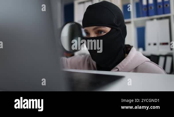 Robber wearing a mask and searching for information using magnifying ...