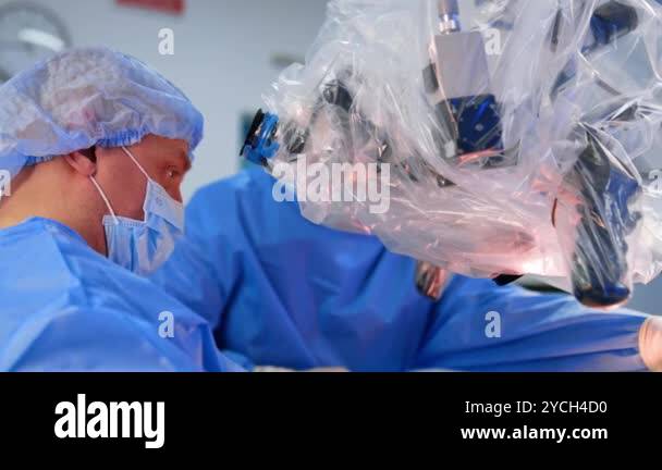 Professional male surgeon takes a tool device. Neurosurgeon looks at ...
