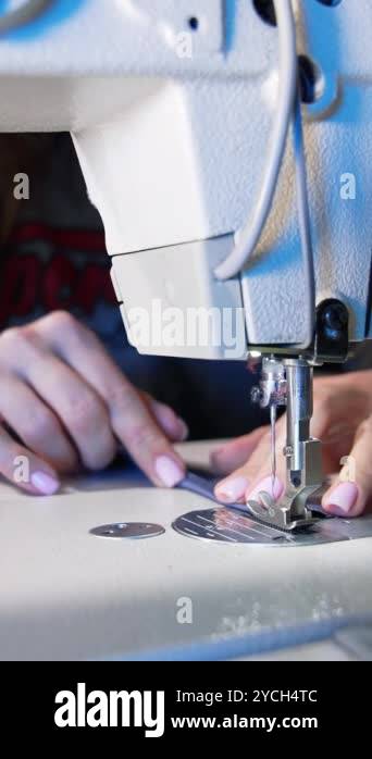Process of sewing fabric on a sewing machine. Tailor working with ...
