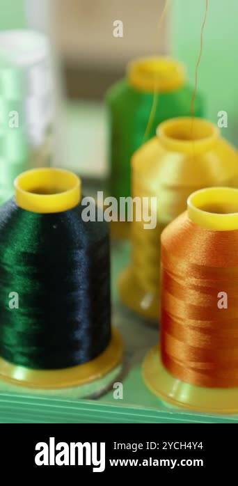 Bright threads in spools for tailor. Colorful spools with threads for ...
