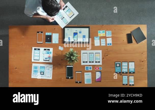 Top view of business man looking and choosing Ux Ui design at meeting room. Skilled developer ...