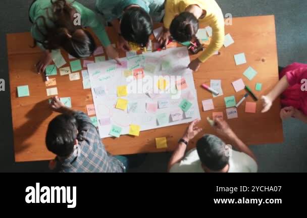 Top view of project manager writing and sticking stick notes. Aerial ...