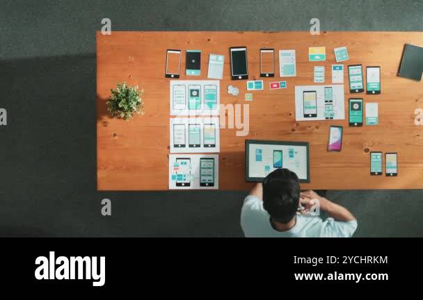 Top view of skilled developer walking and placing Ux Ui software. Smart ...