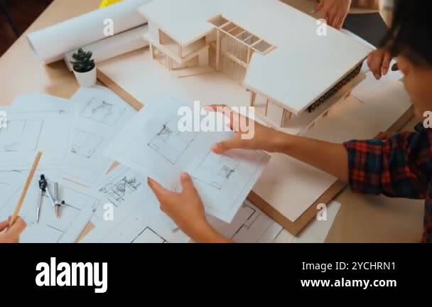 Interior designer drafting blueprint with customer supervise and ...