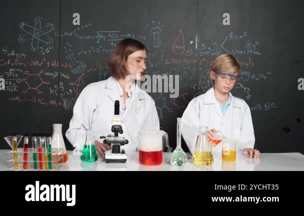 Caucasian teacher explained about colored solution at science ...