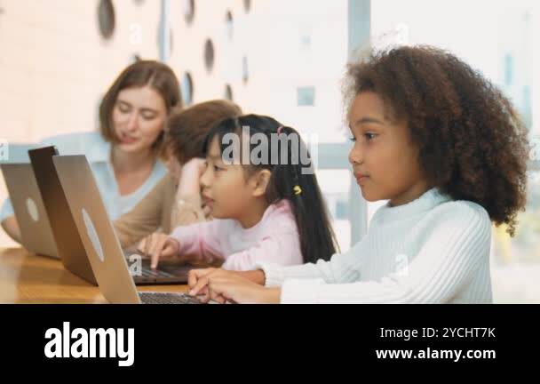 African girl play laptop with diverse friend learning prompt at STEM technology class ...