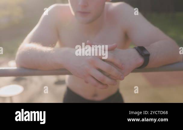 male athlete taking a breather after a tough workout on sports ground ...