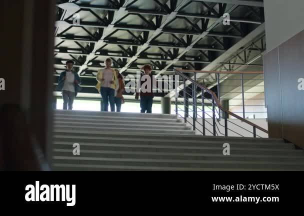 Four Caucasian students active running hurry rush pupils girls guys ...