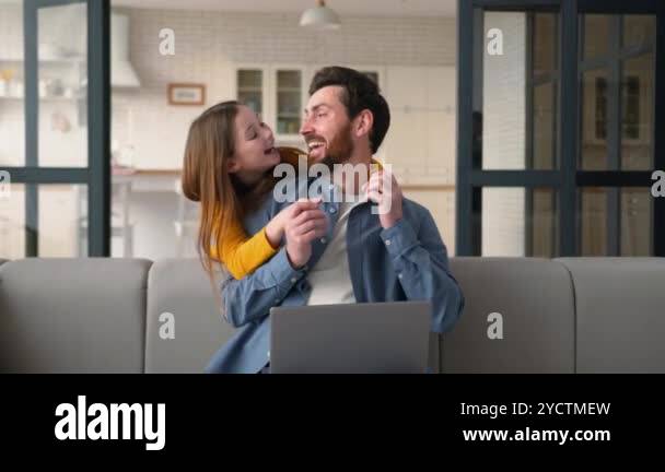 Laughing carefree Caucasian family cheerful little daughter kid hug ...