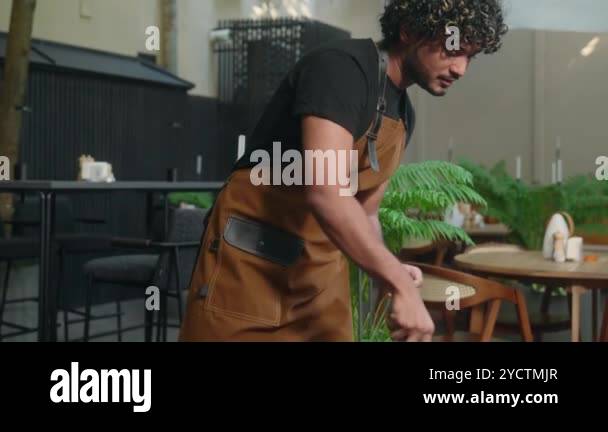 Happy playful Latino American ethnic male man guy in apron waiter ...