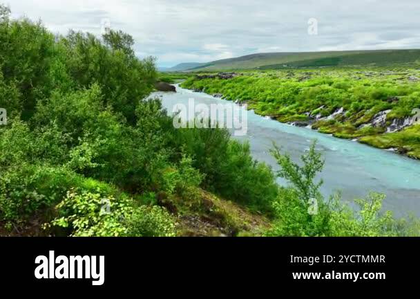 Blue glacial river with many small waterfalls, stunning birds eye view ...