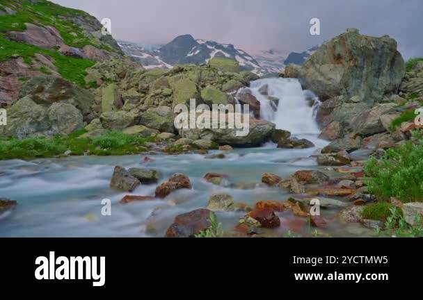 Powerful stream of clean water quickly flows along mountain river ...
