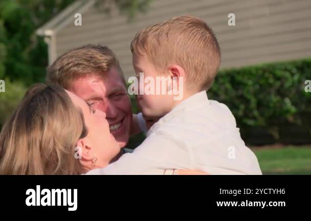 A heartwarming video of a family of four hugging in front of a ...