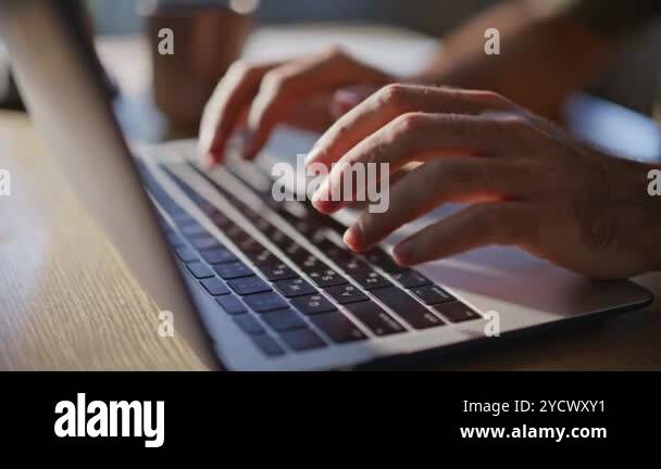 Man hands typing keyboard of laptop computer in office closeup. Businessman fingers working ...
