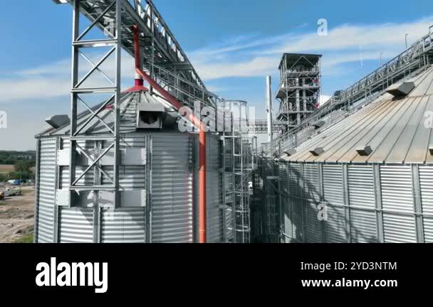 Grain storage facility with metal structures and blue sky. A modern ...